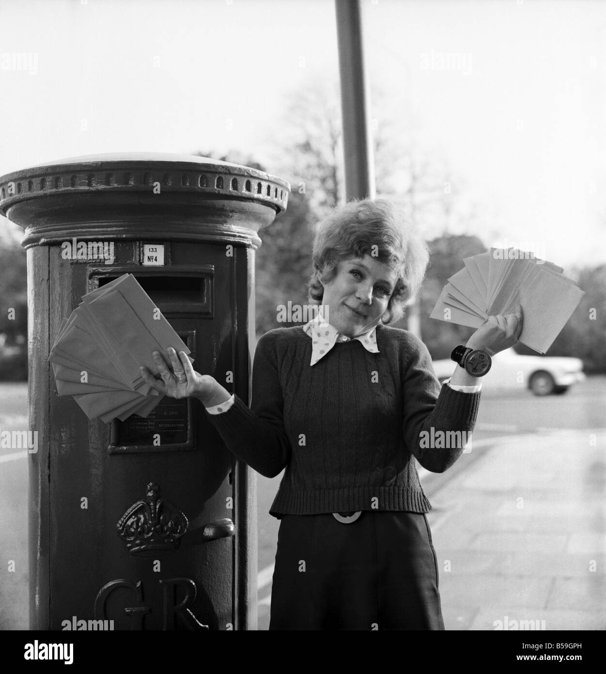 Communications: Woman holding a large collection of letters as she ...