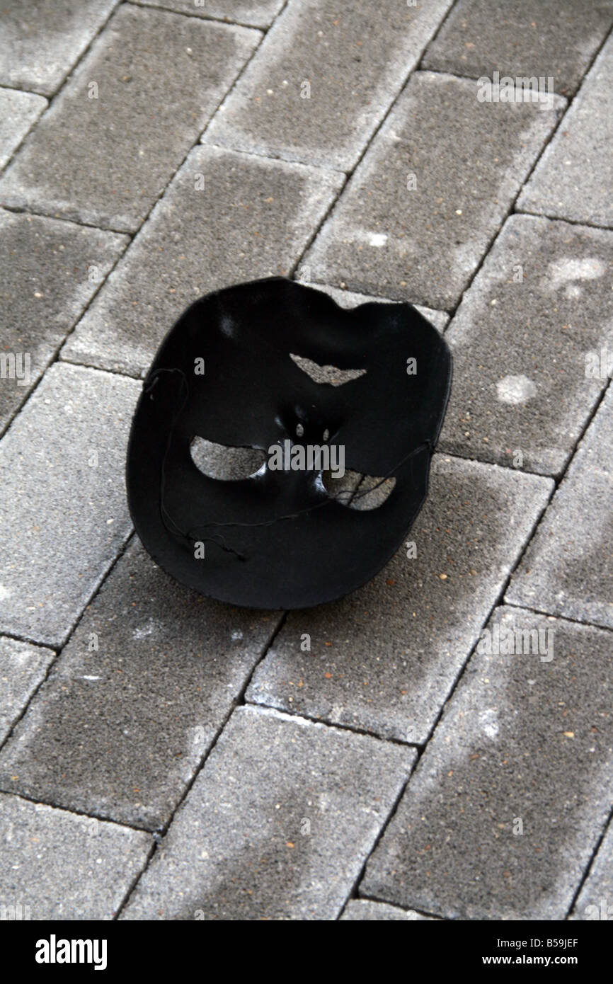 one black full face mask left on floor in street Stock Photo - Alamy