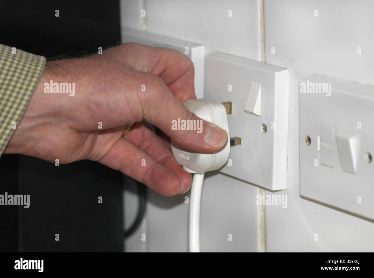Unpluging a plug Stock Photo - Alamy