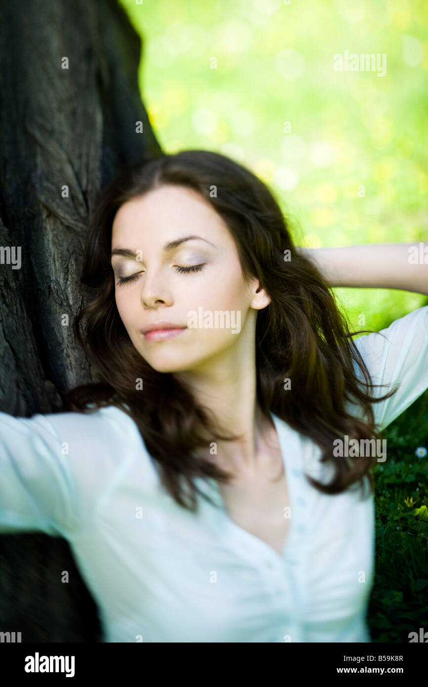 young woman relaxing under tree Stock Photo - Alamy young woman relaxing under tree Stock Photo - Alamy