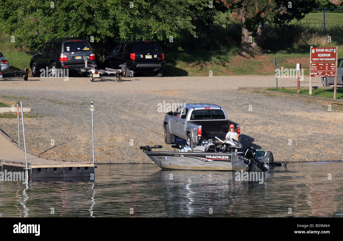 A fishing boat unloading at the shore getting ready to load on the ...