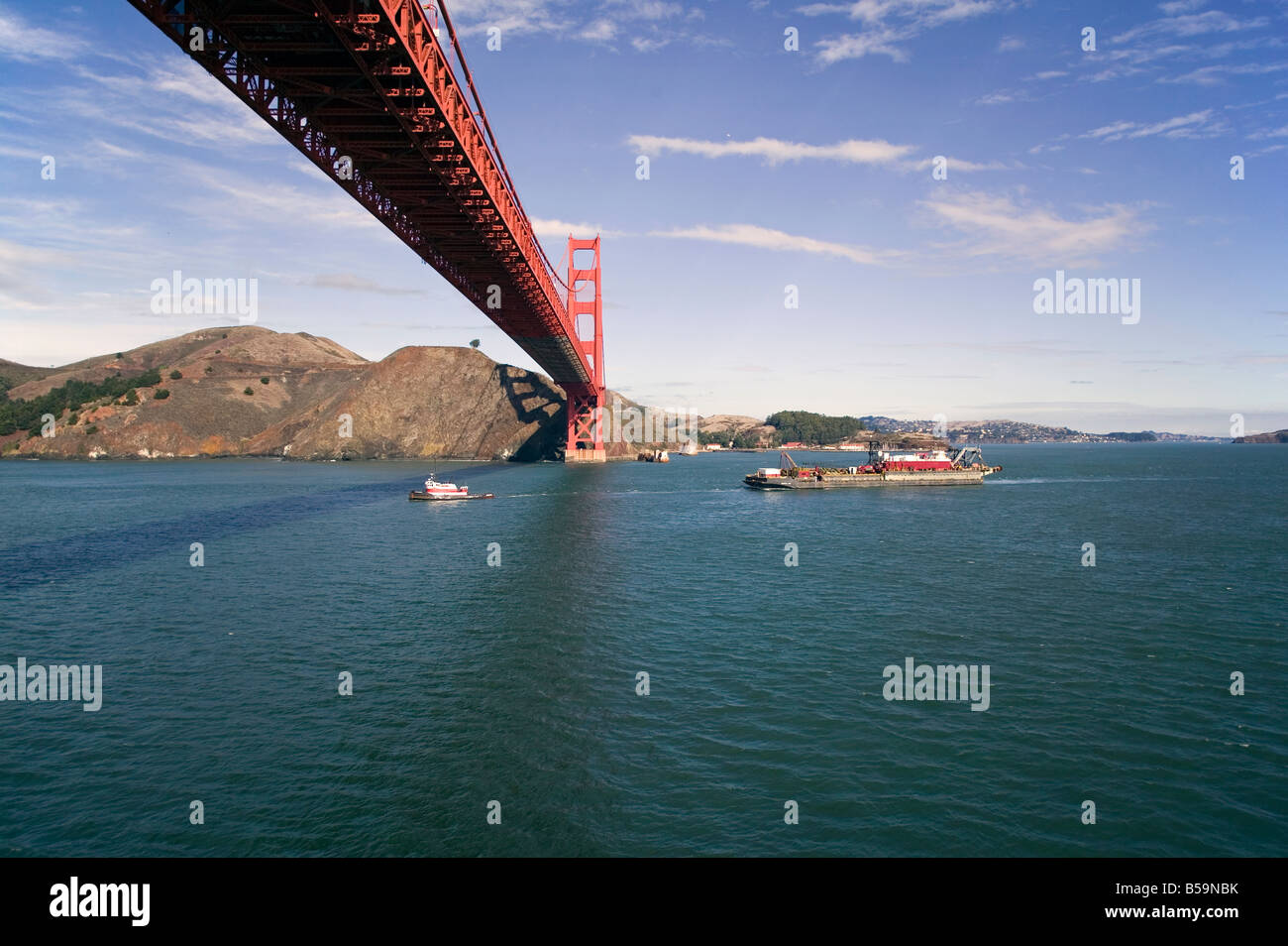 tug boat pulling barge under Golden Gate bridge Stock Photo - Alamy