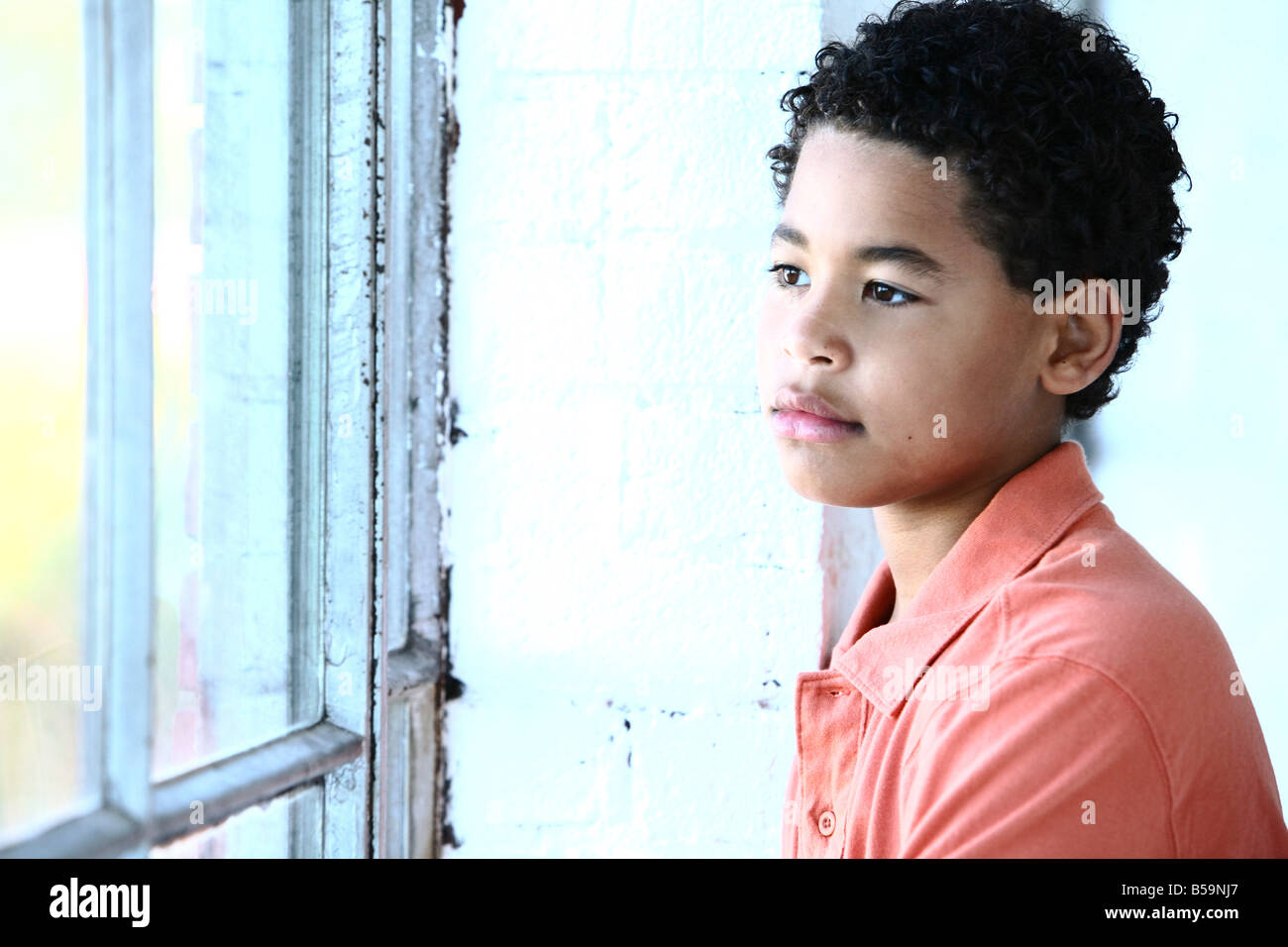 Boy looking out the window Stock Photo - Alamy