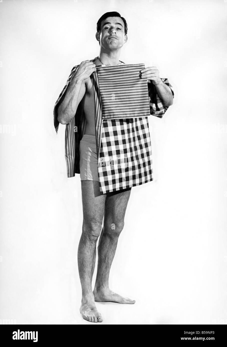 Model Peter Anthony wearing a smock top holding his folded clothes and ...