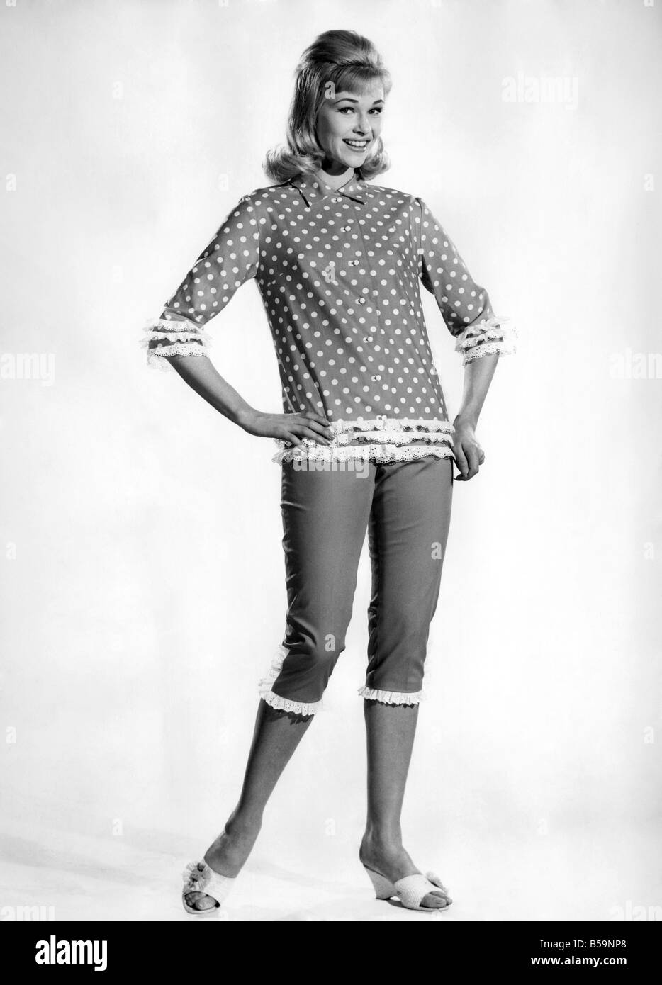 Model Jo Waring wearing a polka dot patterned top and three quarter ...