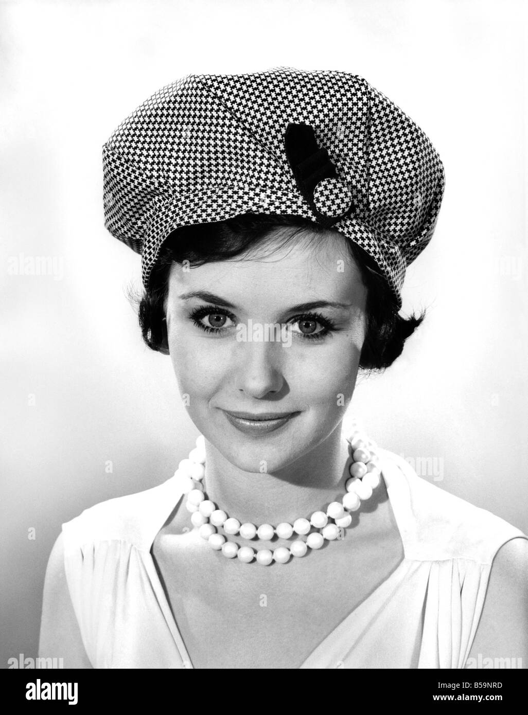 Model Ann Cave wearing a patterned stylish hat with pearl necklace. May ...