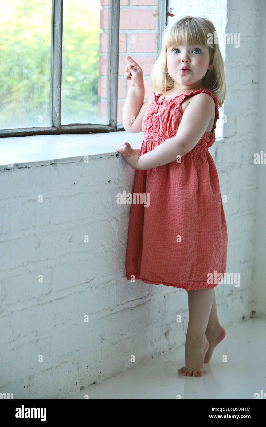 Young girl pointing out the window Stock Photo - Alamy