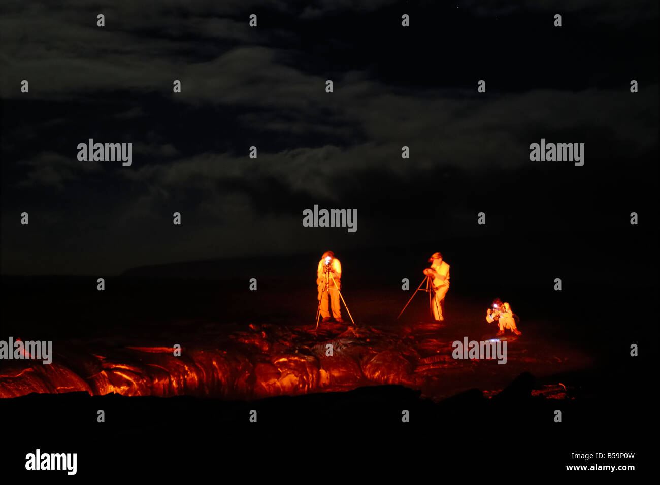 Group of people viewing a skylight and flowing lava Stock Photo - Alamy