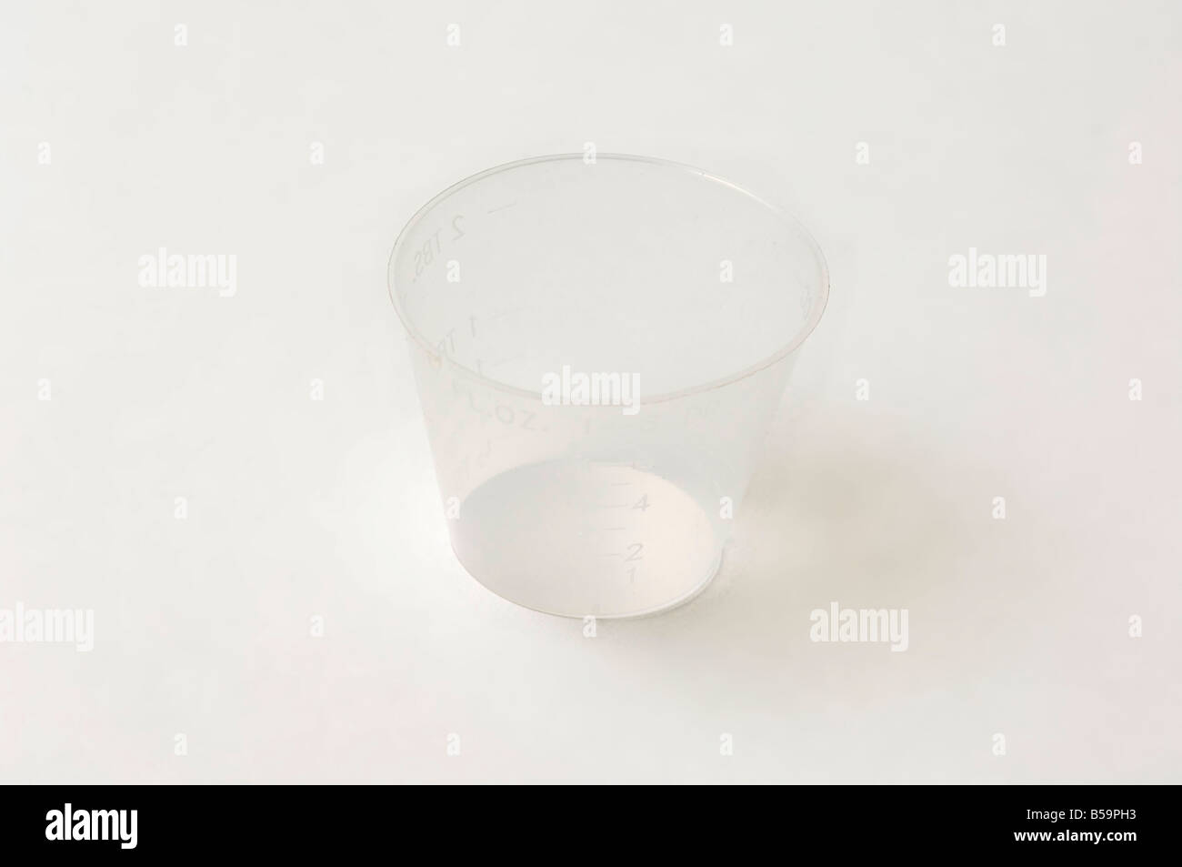 A medicine cup or sample cup used in the health industry Stock Photo ...