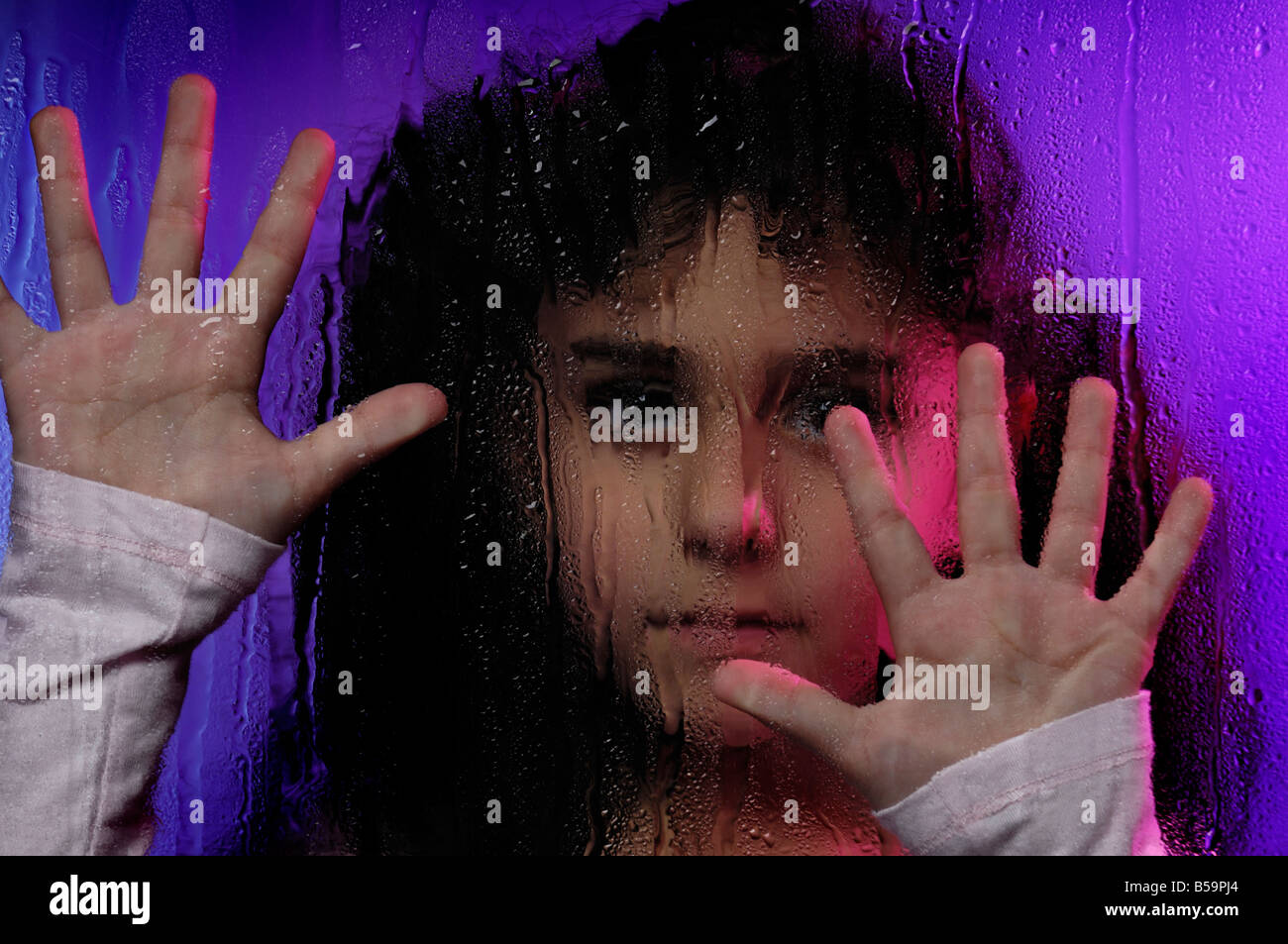 Child behind window in rain Stock Photo - Alamy