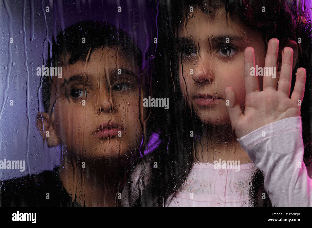 Two children behind window Stock Photo - Alamy