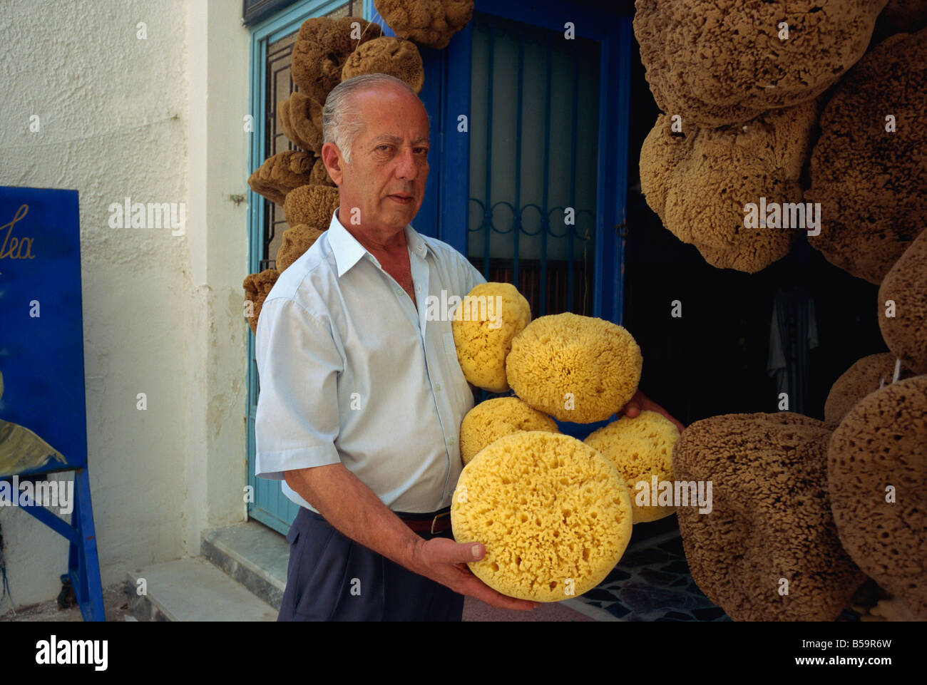 Portrait of a man selling sponges in the port of Pothia on Kalymnos in ...