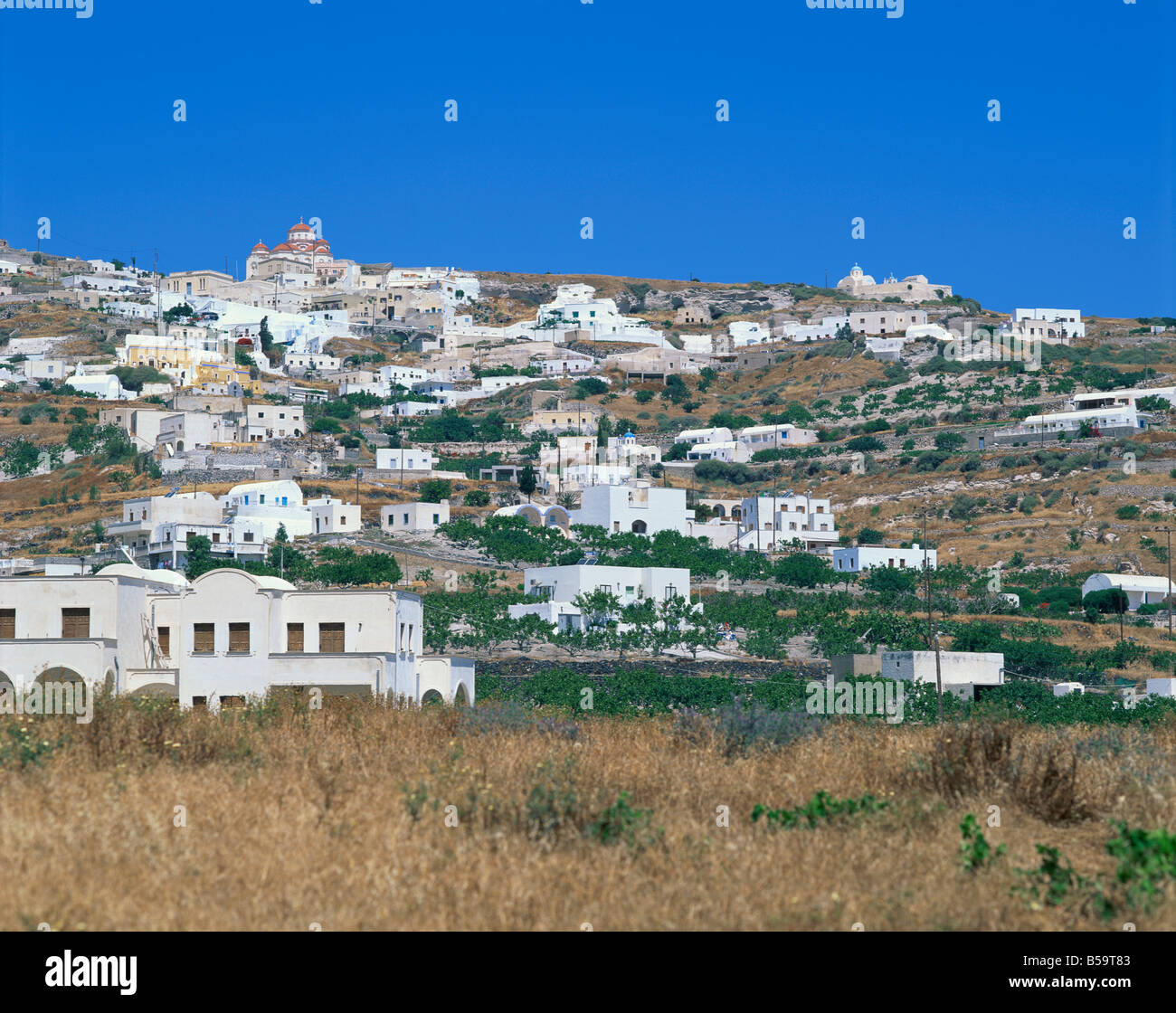 White buildings in village on a hillside with church on skyline, near ...