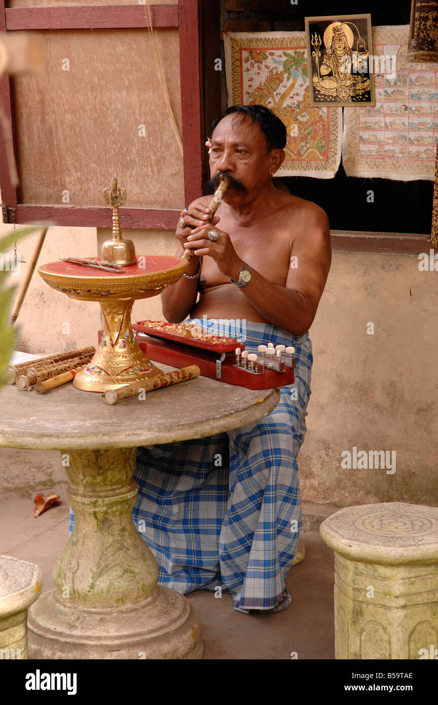 Balinese man is piping flute, Bali Aga village in Tenganan,Bali ...