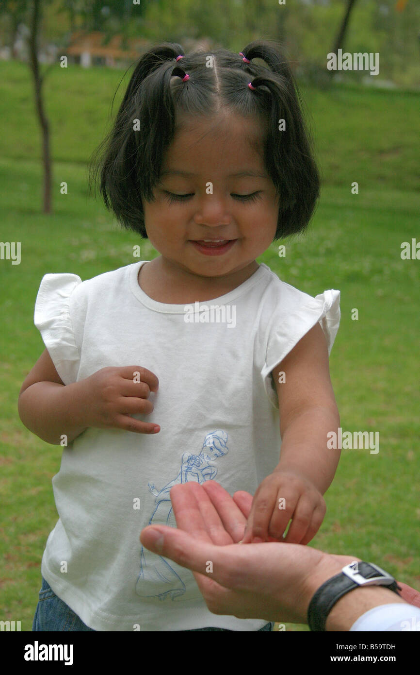 Father and adopted son playing at the Peruvian park. Multicultural ...