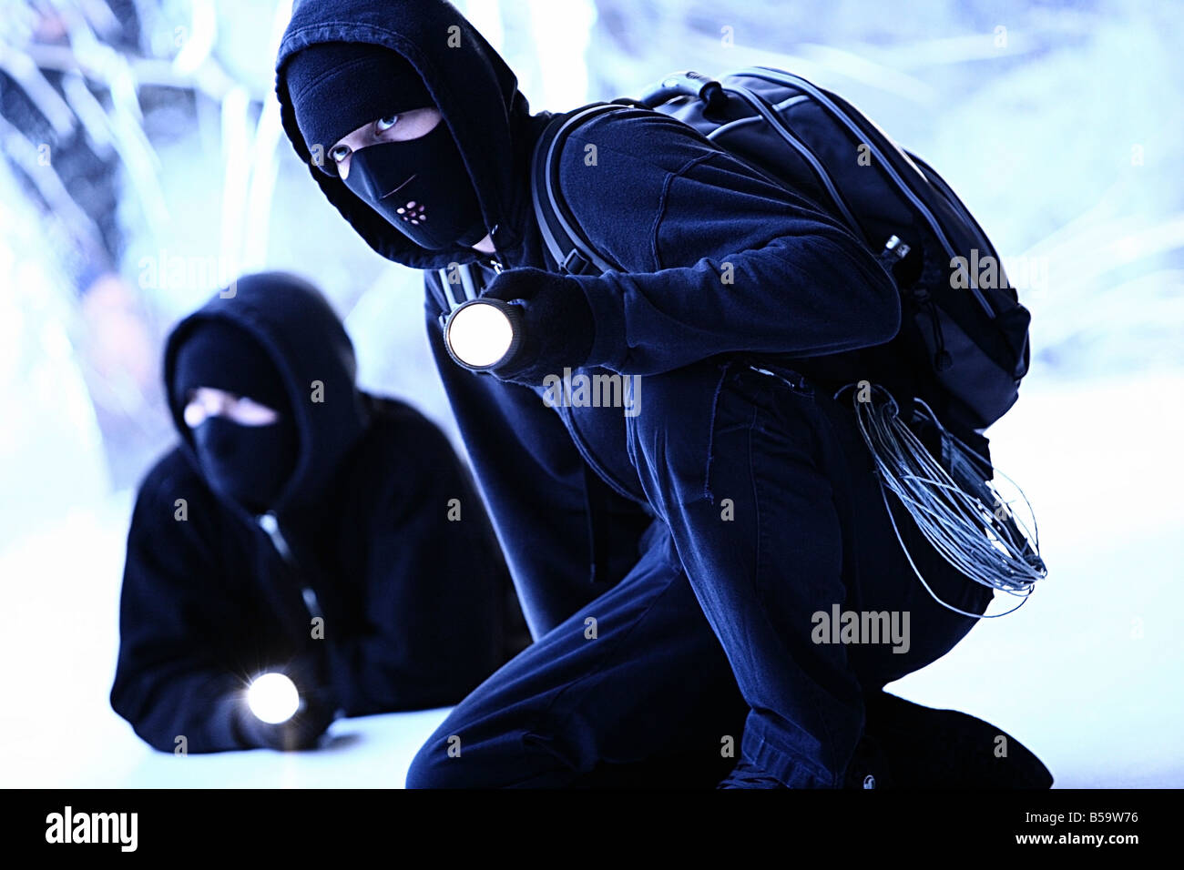 Two thieves dressed in black Stock Photo - Alamy