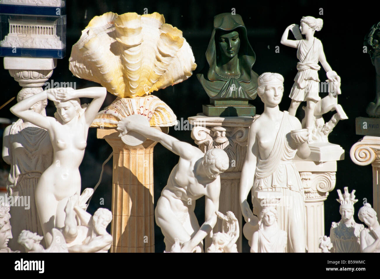 Reproduction sculptures and statues displayed in a souvenir shop window ...