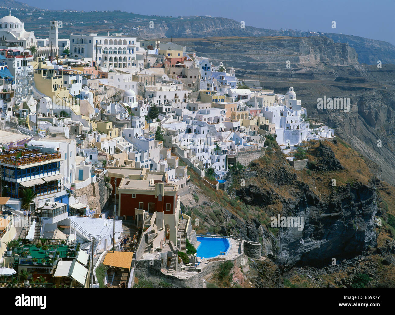 Houses including one with a swimming pool on the hillside in the town ...