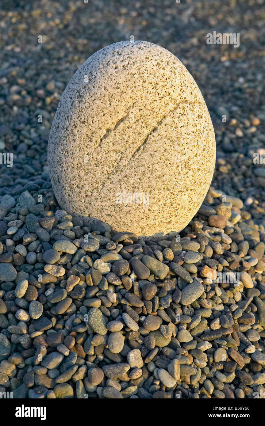 Rock standing in pebbles Stock Photo - Alamy