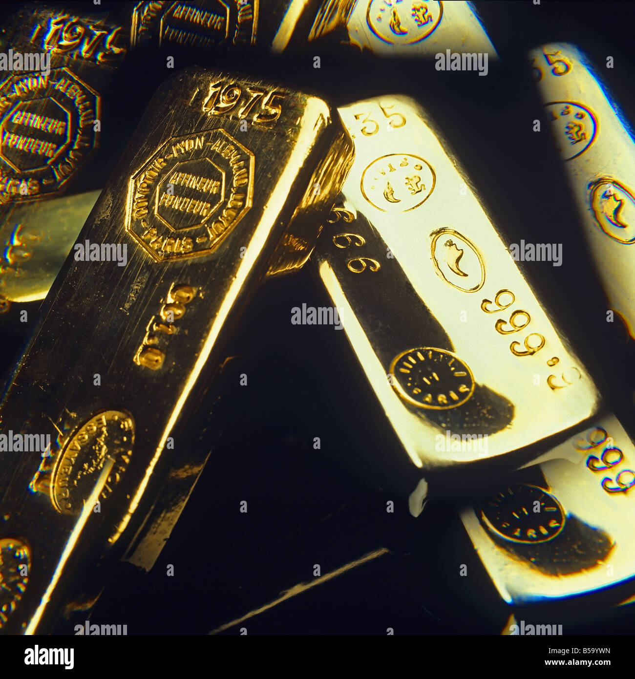Multiple image of 2 gold bars on black background Stock Photo - Alamy