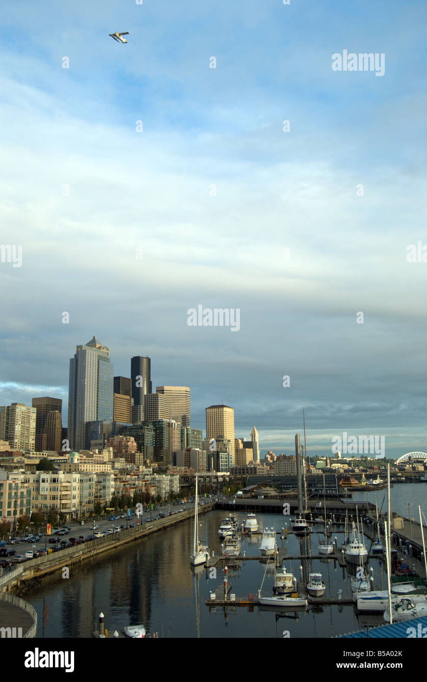 A Kenmore Air seaplane flies over downtown Seattle and the Bell Harbor ...