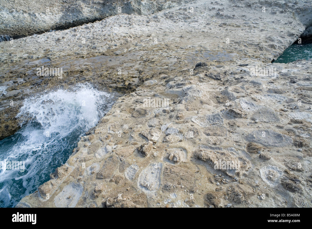 Surface of white rocks, forming a natural bridge over the water, made ...