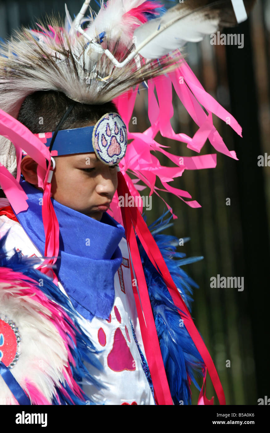 A teenager Native American Indian boy dancing at a Pow Wow at the ...