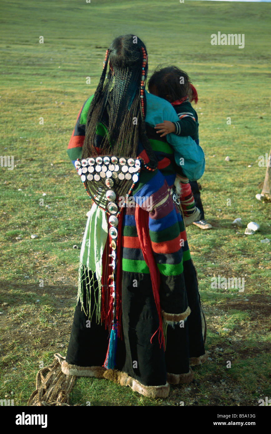 Back view of Tibetan dress with silver ornaments on long plaited hair ...