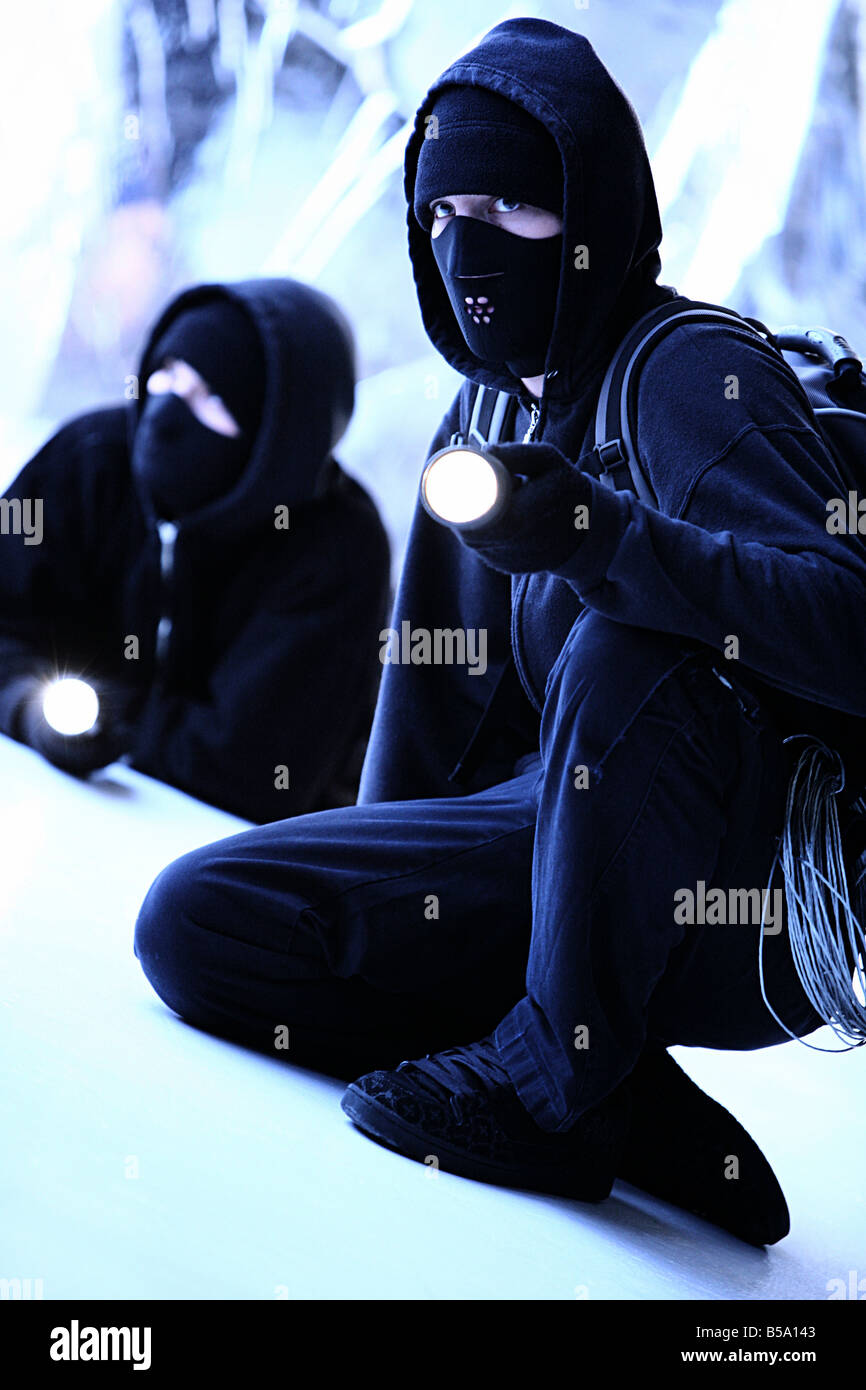 Two thieves dressed in black Stock Photo - Alamy