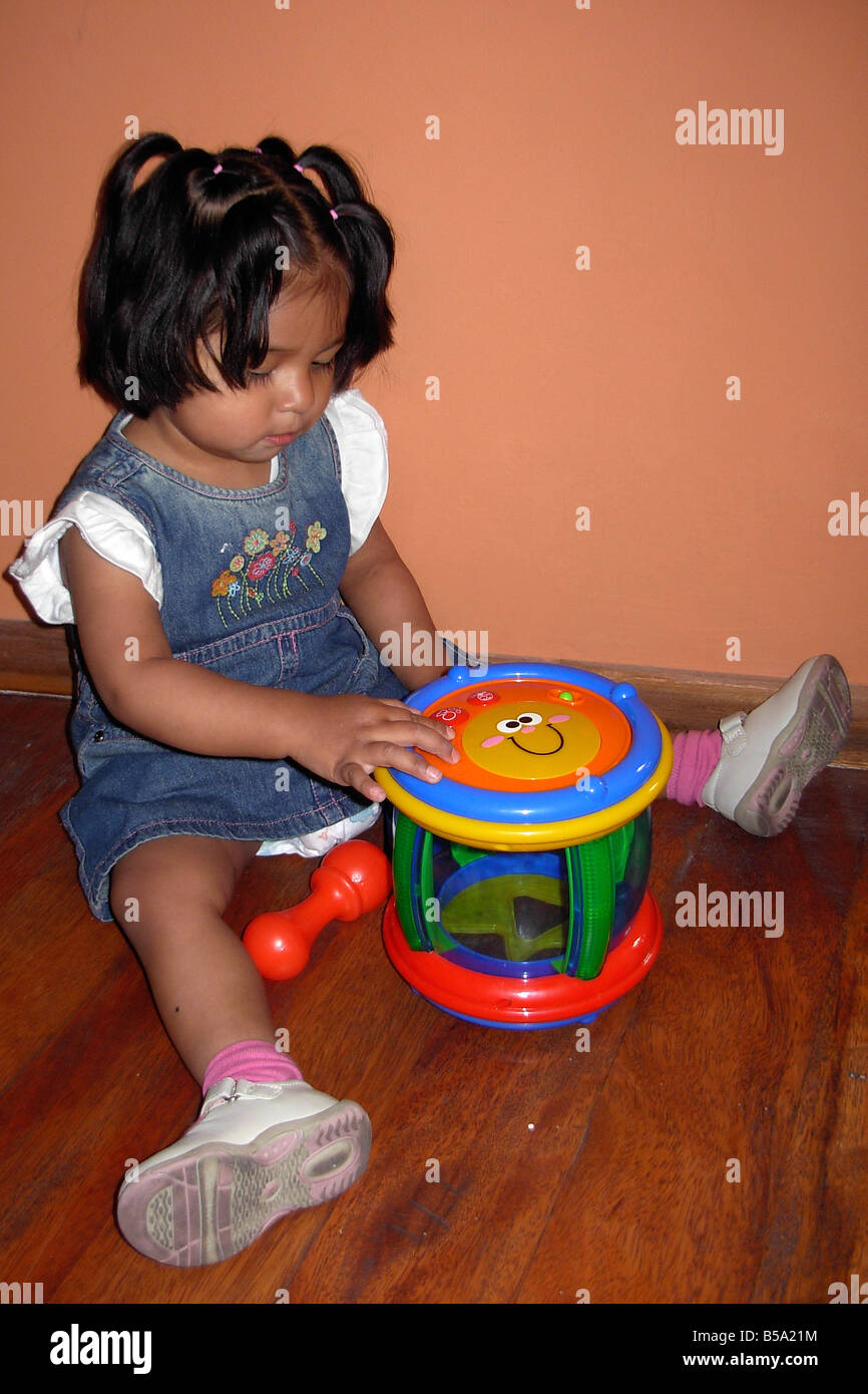 Baby is playing tambourine Stock Photo - Alamy
