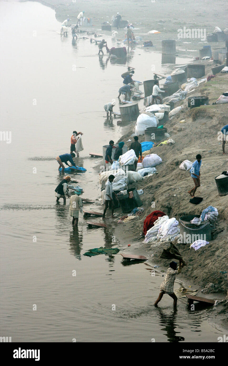 Men washing clothes at sunrise in River Yamuna, Agra, Uttar Pradesh ...