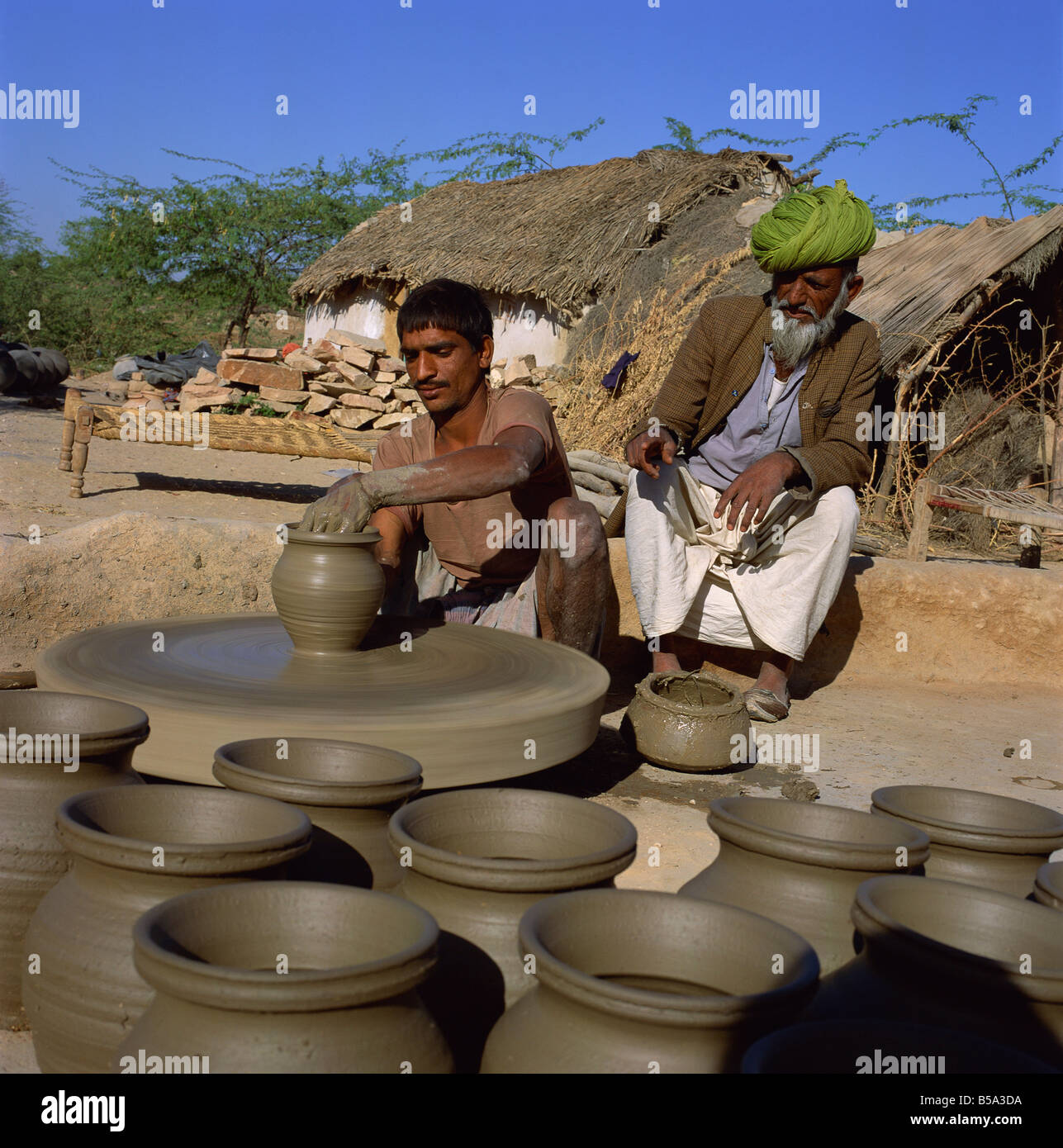 Potter with his father at potter s wheel Rajasthan India Asia Stock ...