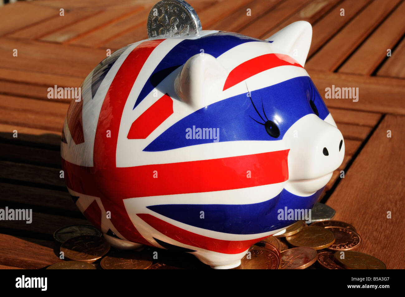 British Sterling piggy bank painted in the colours of the British red ...