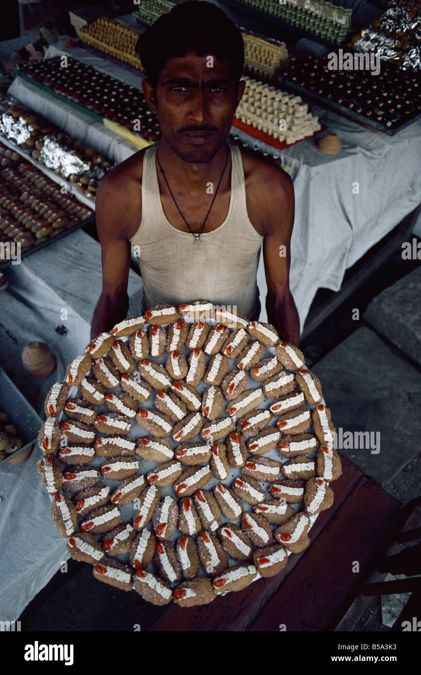 Man selling sweets India Asia Stock Photo - Alamy