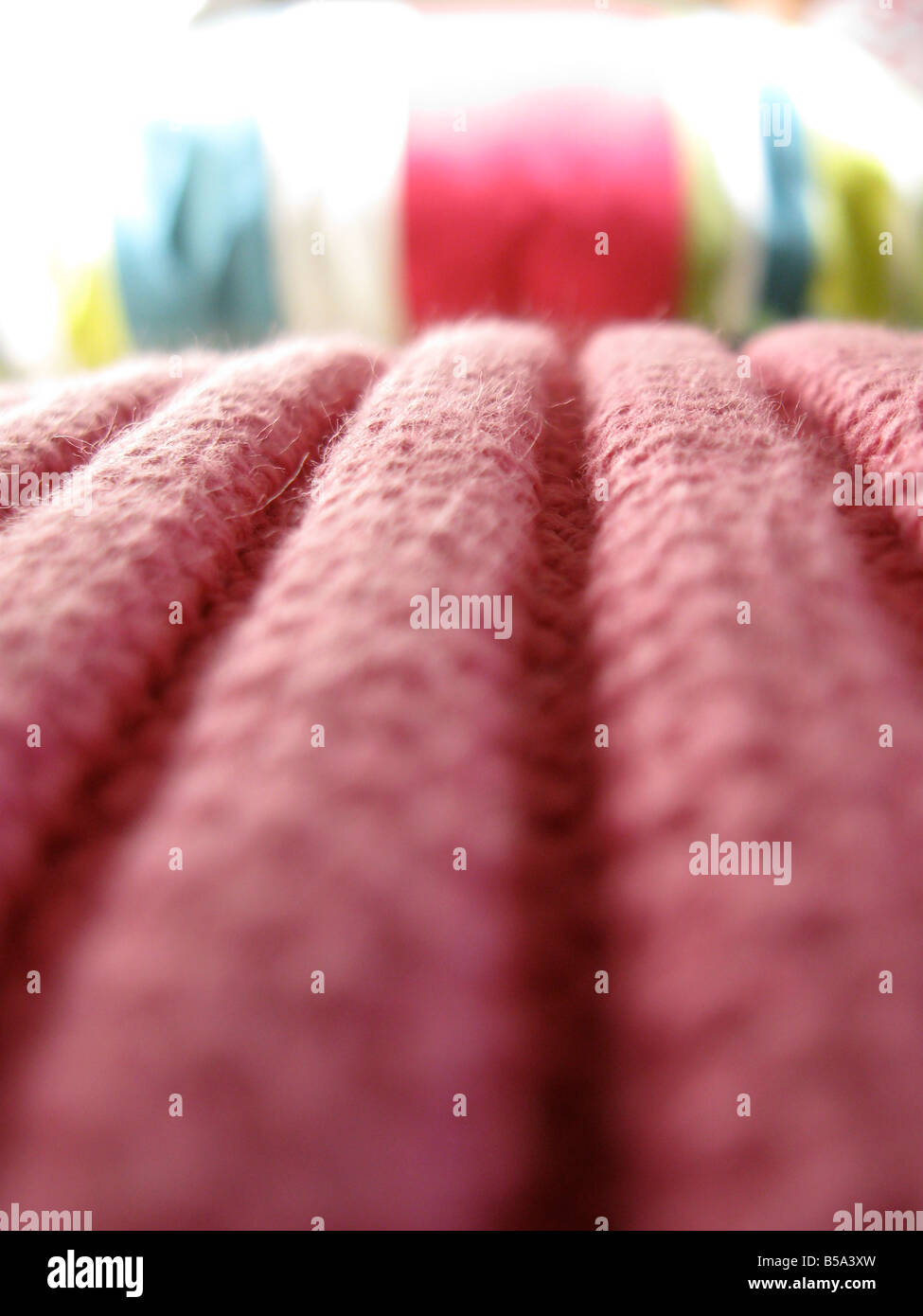 A close up of a pink cushion with different colours colors in the ...