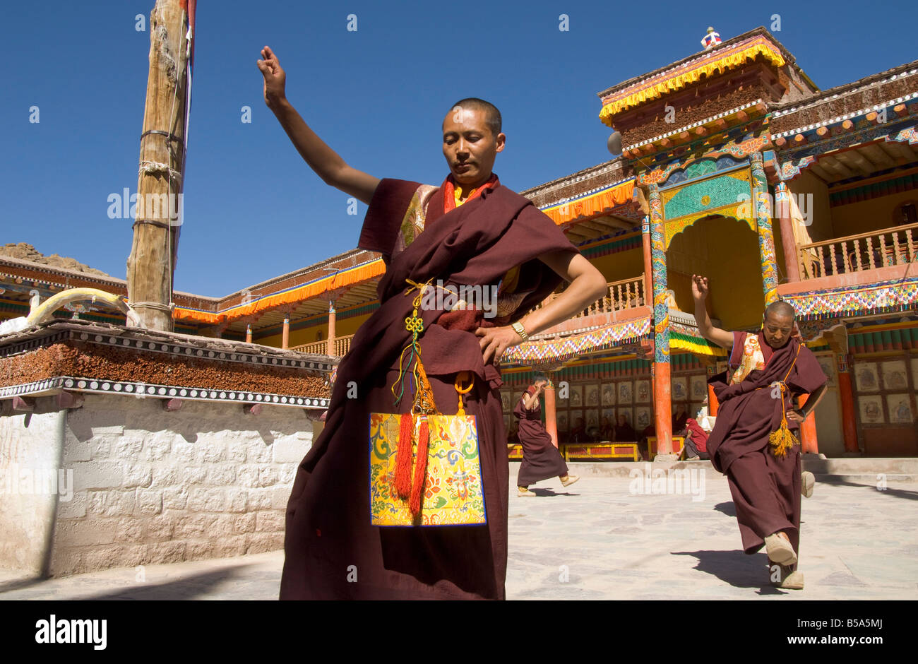 Group of monks dancing in the monastery courtyard rehearsing for Hemis ...