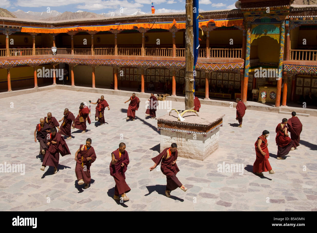 Group of monks dancing in the monastery courtyard rehearsing for Hemis ...