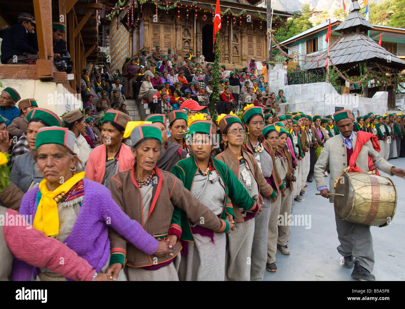 Women in full traditional clothes dancing in a row, Baring Narj temple ...