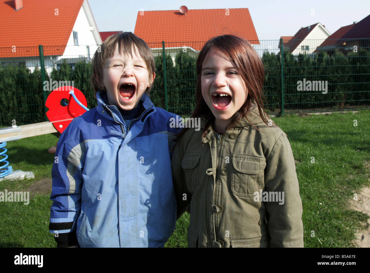 A boy and a girl screaming loudly Stock Photo - Alamy