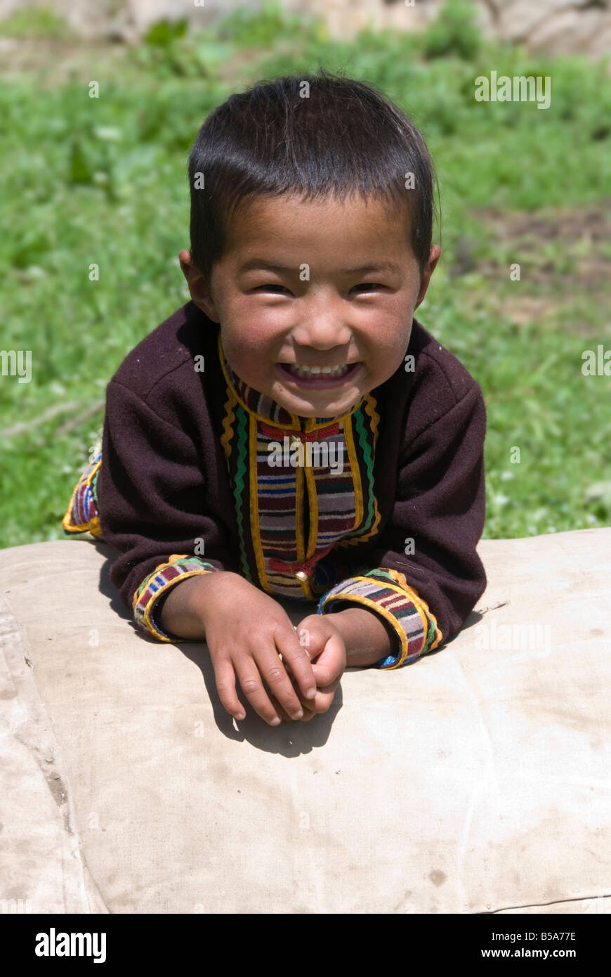 Smiling Tibetan child in a rural village on the nomadic grasslands in ...