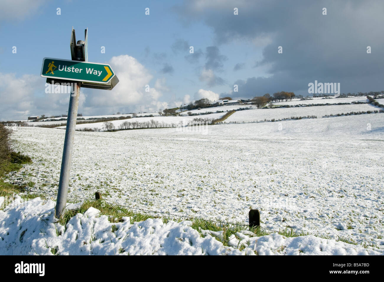 Ulster Way sign with snow on fields in background Stock Photo - Alamy