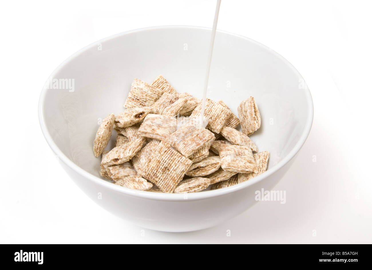 Wheat breakfast cereal in a white bowl isolated on a white studio ...