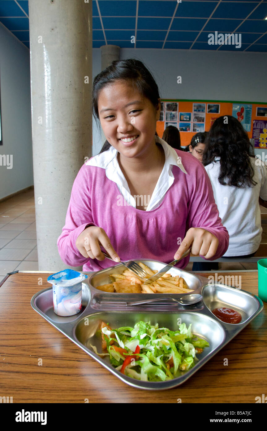Teenage girl student having formal healthy balanced lunch in school ...