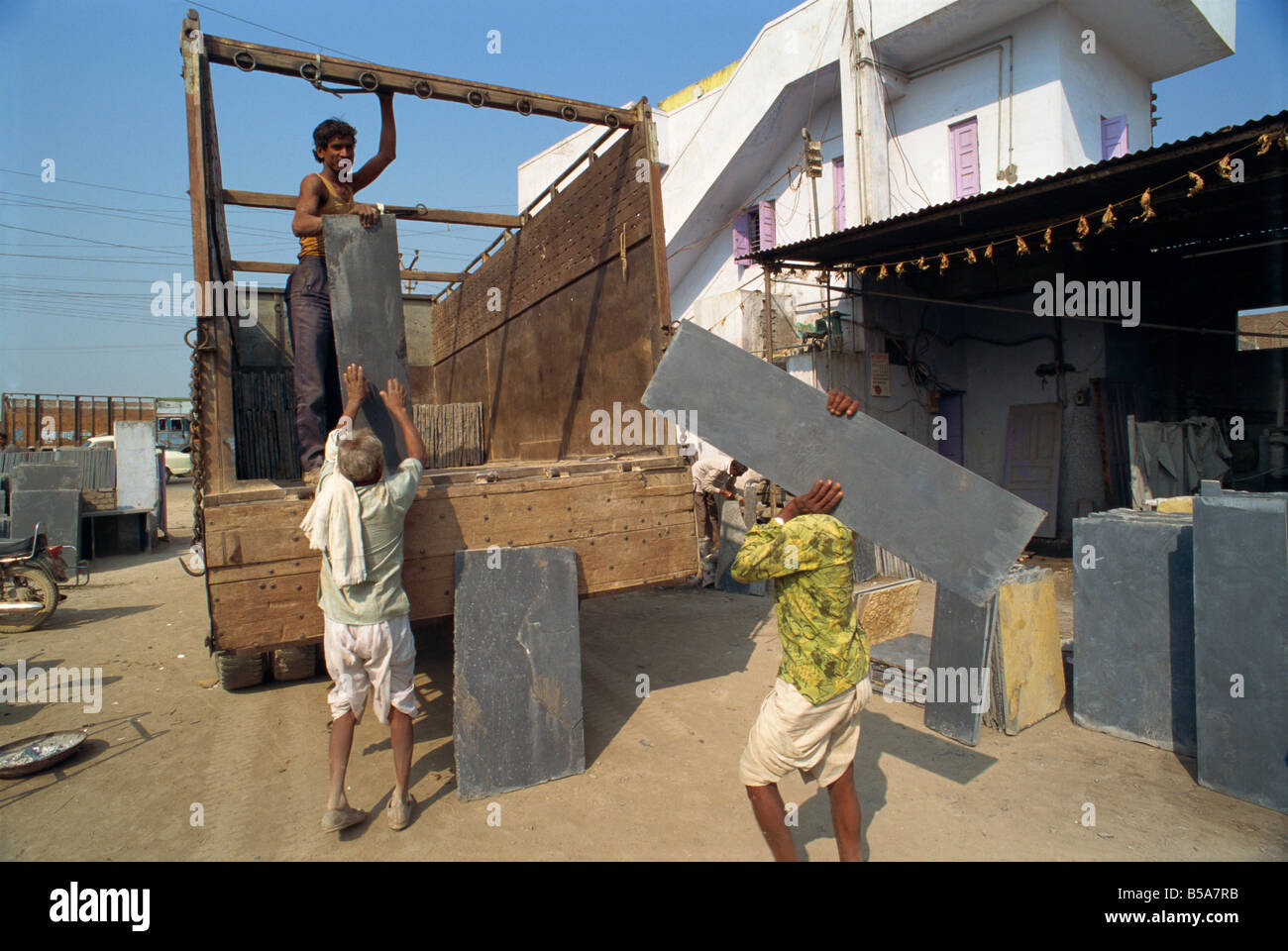 Stonemasons loading stone onto truck Chittorgarh Rajasthan state India ...