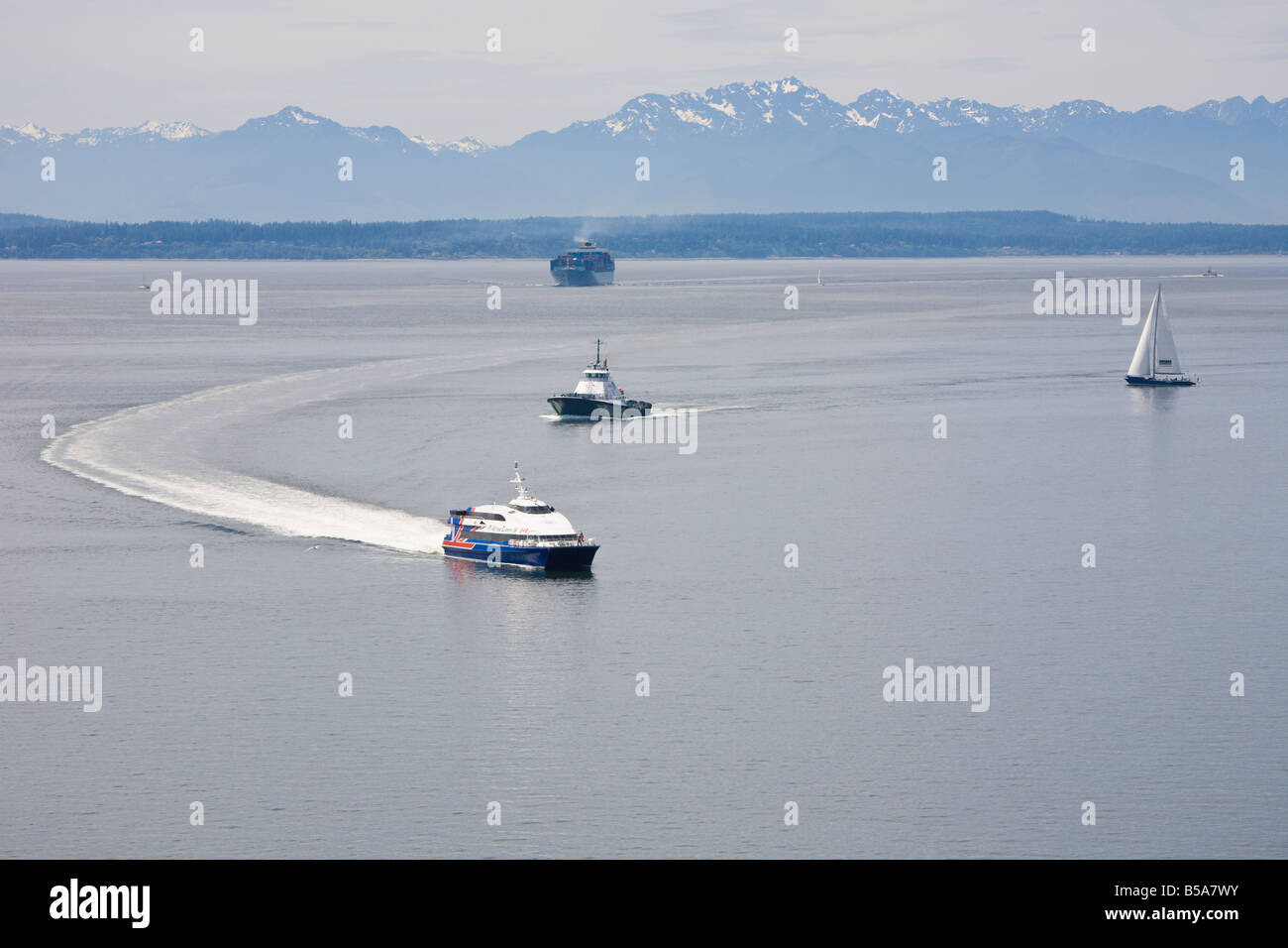 Container ship, tugboat, sailboat, and Victoria Clipper tour boat all ...