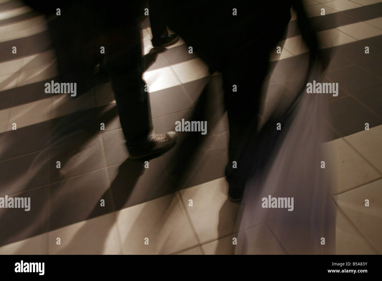 detail of people legs walking fast in street at night Stock Photo - Alamy