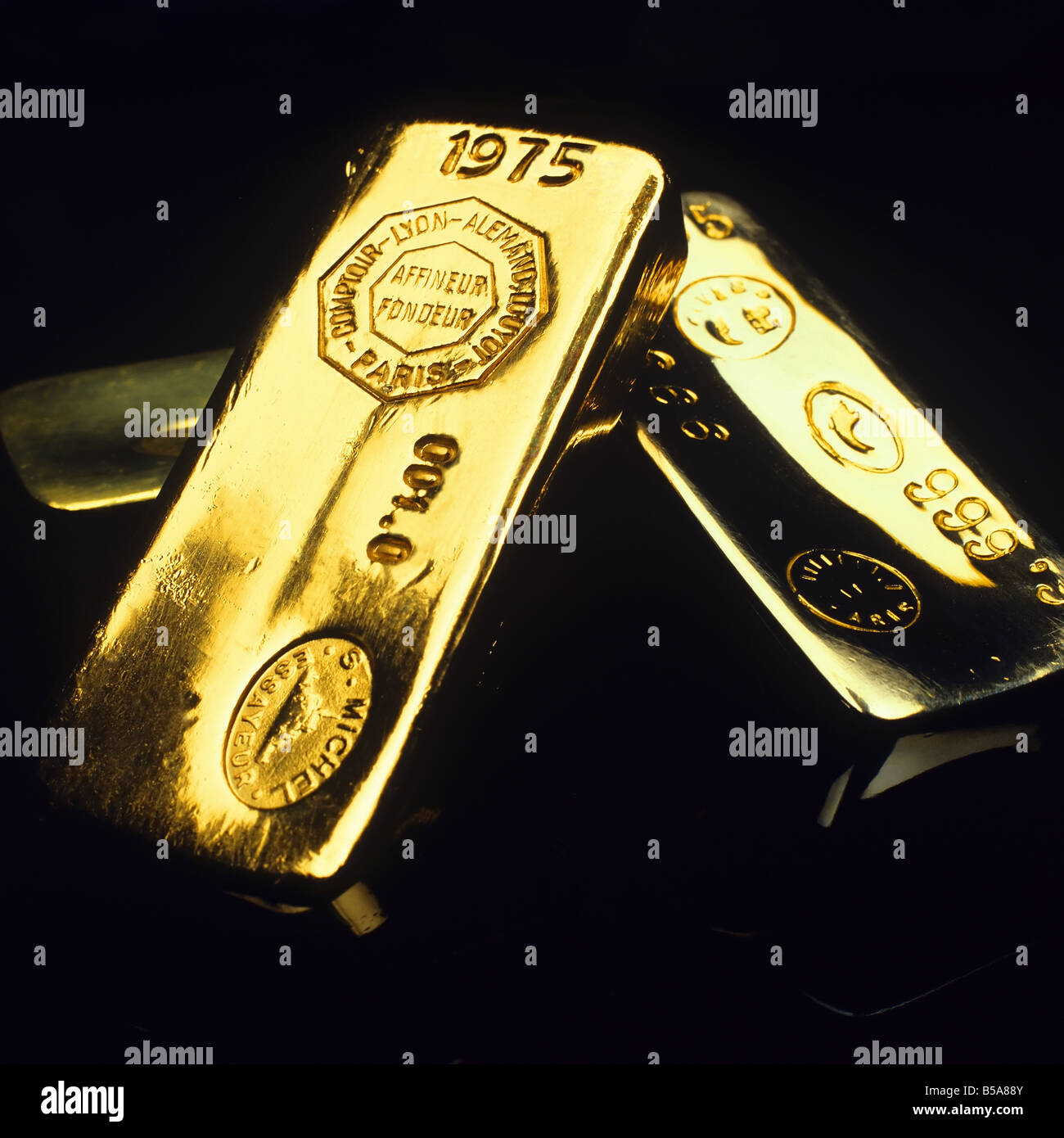 Three gold bars on black background Stock Photo - Alamy