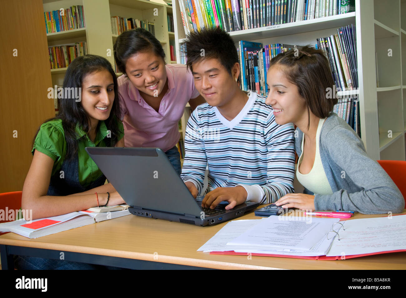 Study group of senior teenage Hispanic Asian & Korean students study ...