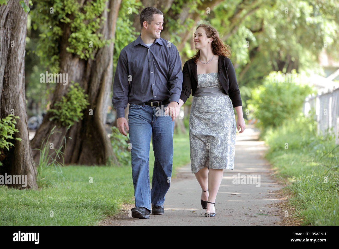 Couple walking along a path Stock Photo - Alamy