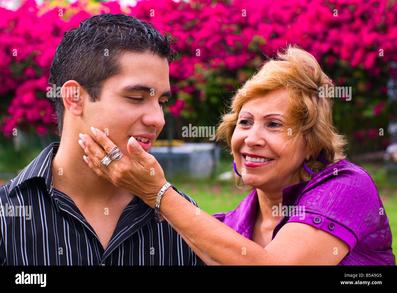 Grandmother lady caressing teen male Stock Photo - Alamy